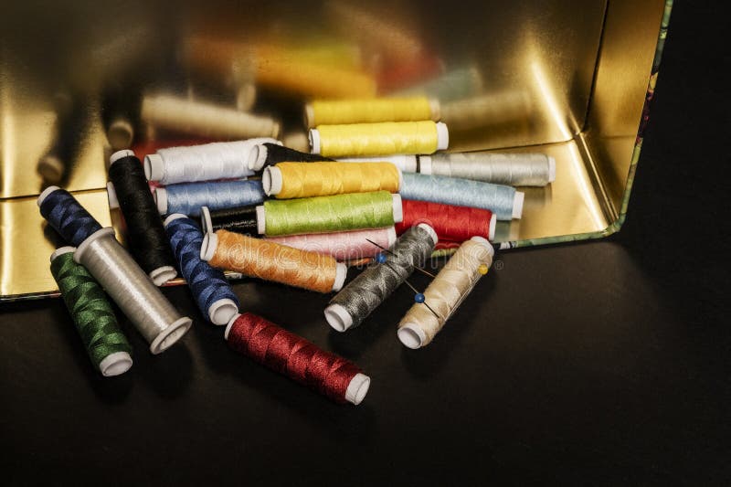 A Tin Box Full of Spools of Sewing Thread Upended on a Smooth Stock ...