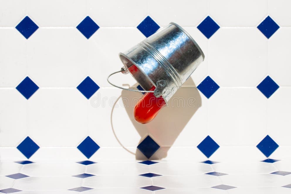 A Tin Bucket Falling To the Floor and a Red Liquid Flows from it Stock ...