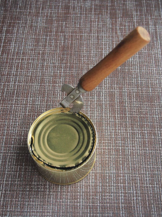 A Tin Can and a Can Opener. the Opening of the Cans Stock Image - Image ...