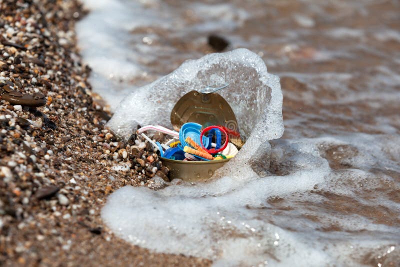 Plastic Garbage on Sea Beach. Disposable Plastic Cup Thrown by Sea Wave ...