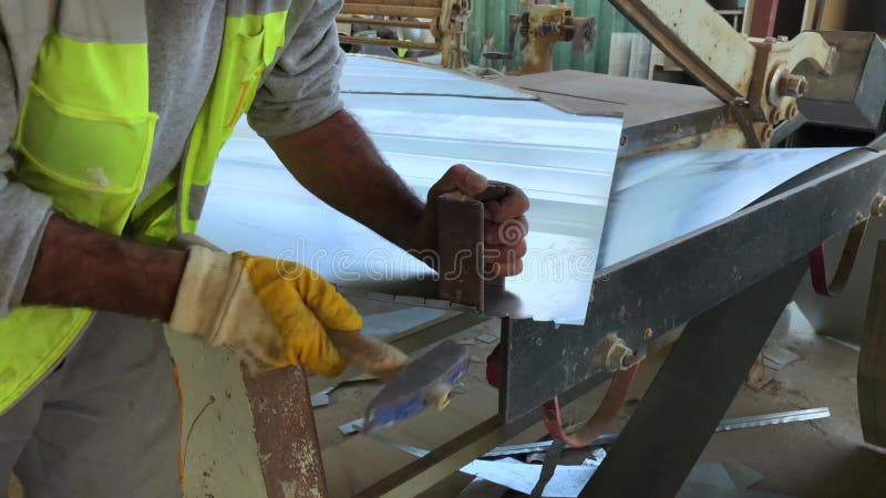 A Man Works with Sheet Metal on a CNC Hydraulic Press Brake. he Lays ...