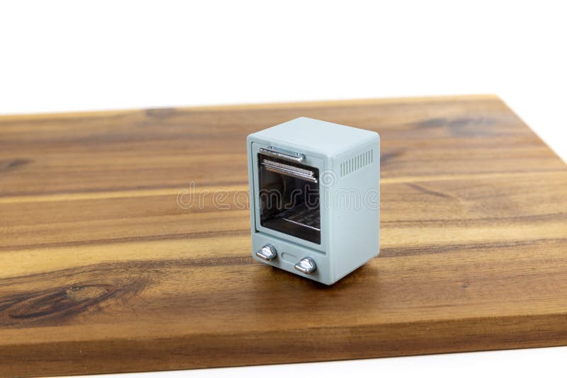 Tiny Blue Toy Oven on a Cutting Board Stock Image - Image of cooker ...