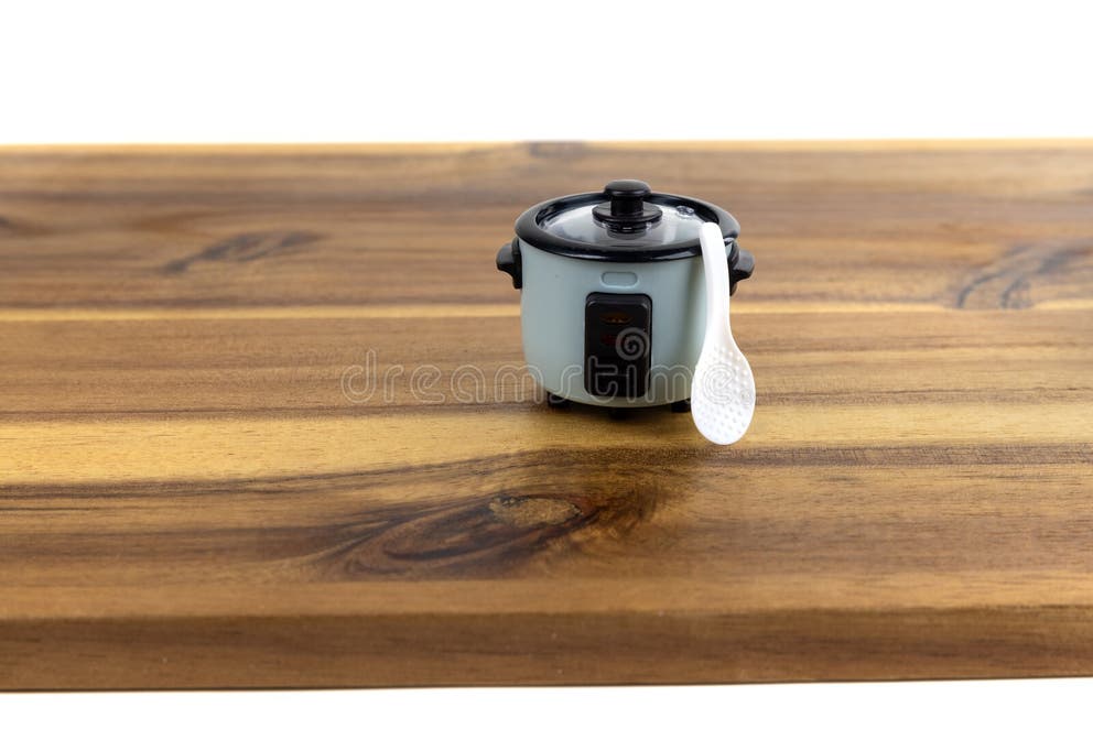 Tiny Blue Toy Rice Cooker with a Spoon on a Cutting Board Stock Photo ...