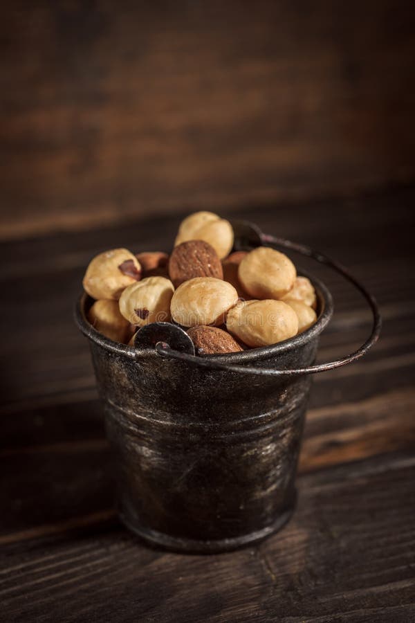 Tiny Bucket of Assorted Nuts on a Wooden Background Stock Image - Image ...