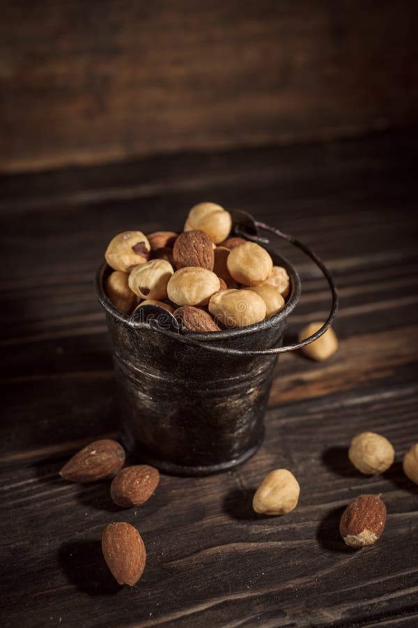 Tiny Bucket of Assorted Nuts on a Wooden Background Stock Image - Image ...