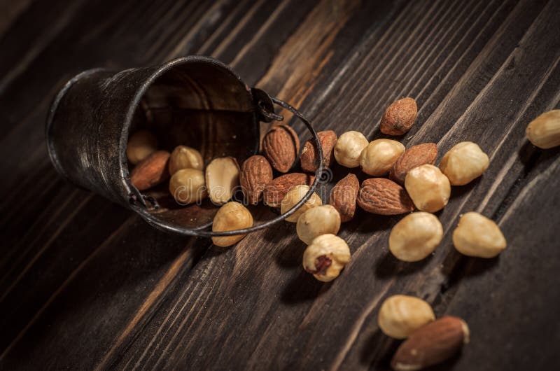Tiny Bucket of Assorted Nuts on a Wooden Background Stock Image - Image ...