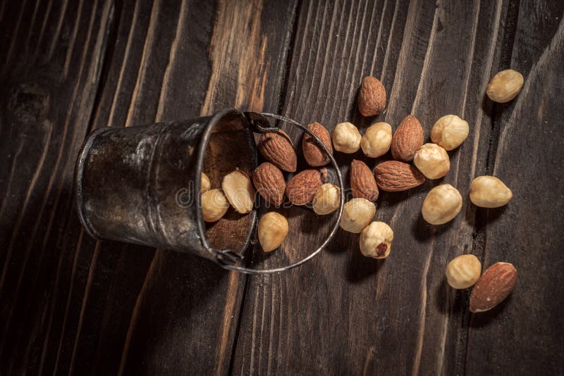 Tiny Bucket of Assorted Nuts on a Wooden Background Stock Image - Image ...
