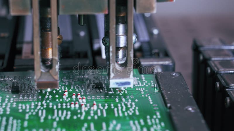 Tiny Components Undergoing Quality Control Checks by a Robotic Arm in an Automated Process ...