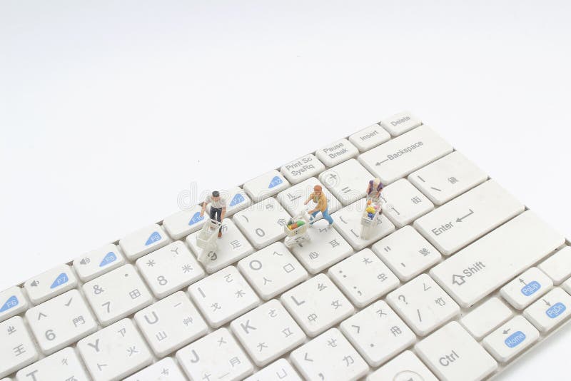 Tiny Figure Shoppers with Shopping Cart on a Computer Keyboard Stock ...