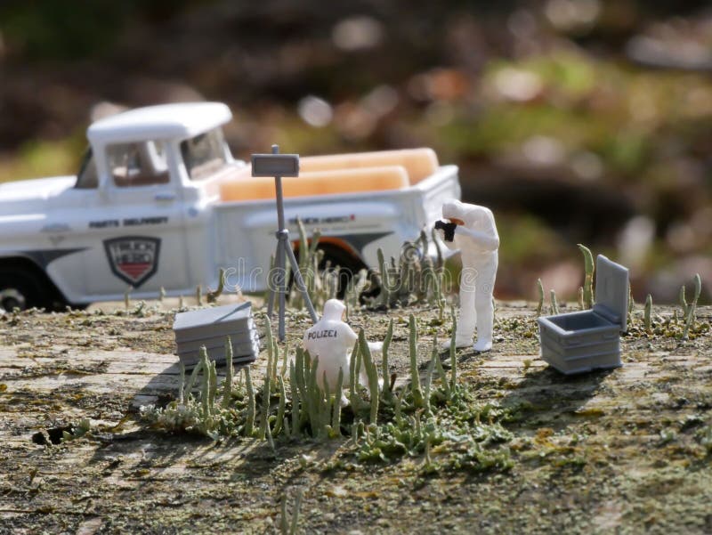 A Closeup Shot of Tiny White Figures Making Photos at Crime Scene ...