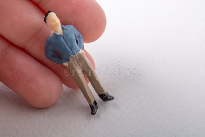 Tiny Figurine of Man Model in Hand Stock Photo - Image of puppet ...