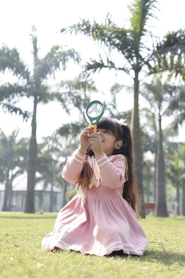Tiny Girl Playing in the Park with Magnifying Glass Stock Photo - Image of fashion, beauty ...