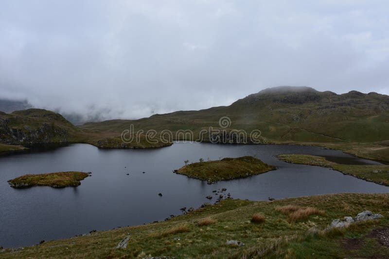 Tiny Islands in Angle Tarn on a Mountain Top Stock Photo - Image of ...