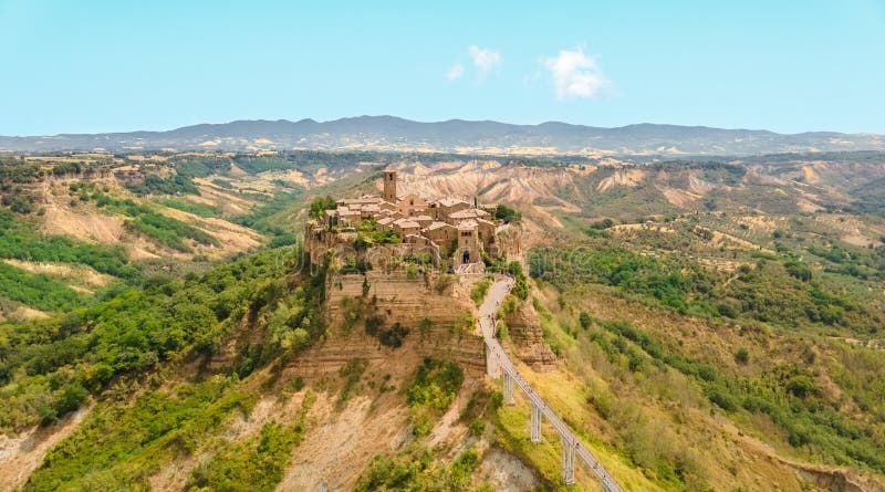 A Tiny Italian Town Stands on a High Cliff with a Long Bridge To it ...