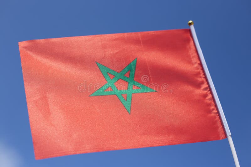Tiny Moroccan Flag Against Blue Sky , Kingdom of Morocco Flag Stock ...