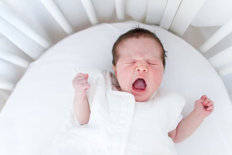 Tiny New Born Baby Screaming Loud in a White Round Crib Stock Photo ...