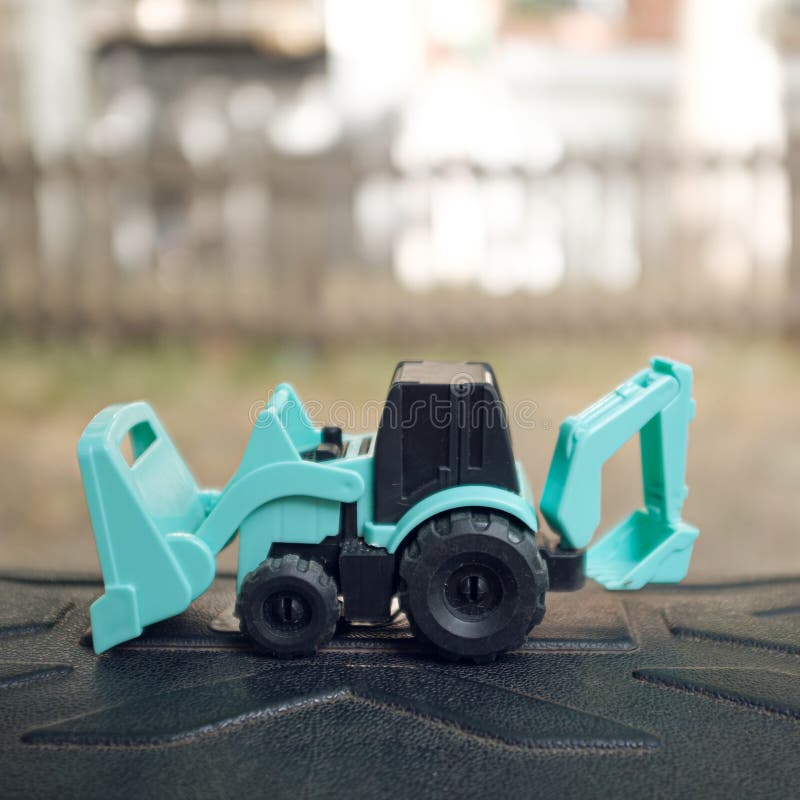 Tiny Plastic Tiny Tractor Toy with Shovels Close Up Still Stock Photo ...