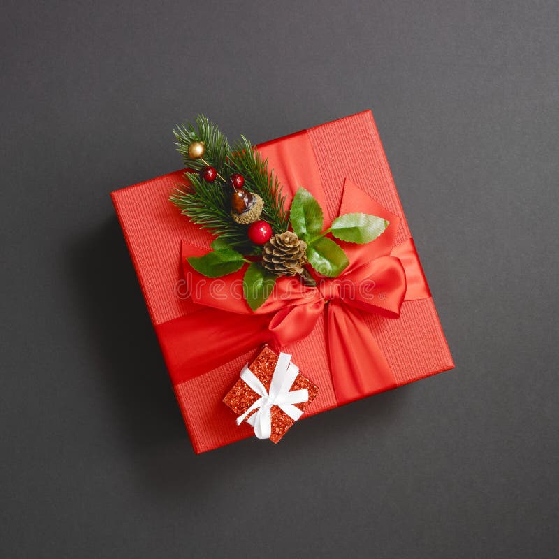A Tiny Red Box Stands on Top of a Larger Gift Box Decorated with a ...