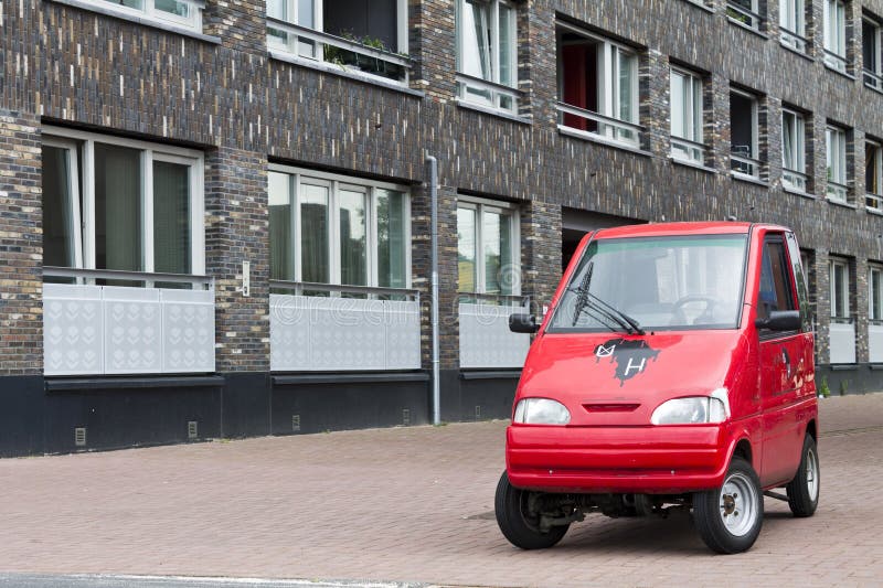 Tiny Red Car by a Building Made of Bricks Editorial Photo - Image of ...