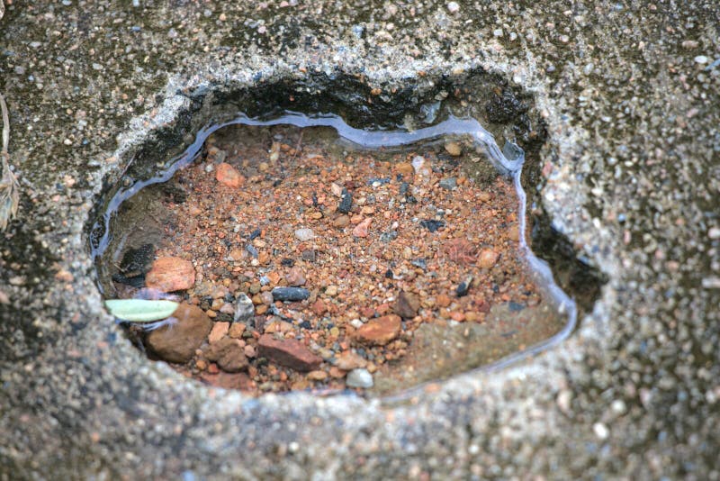 Tiny Puddle of Water in a Hole. Stock Photo - Image of stones, patience ...