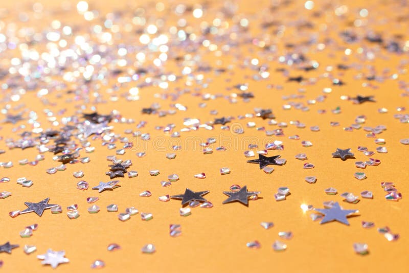 Tiny Silver Stars and Crystals Confetti Scattered on a Yellow ...