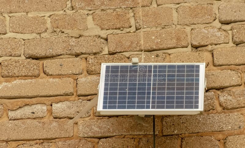 A Tiny Solar Panel on the Brick Wall of an Old Building . Stock Photo ...