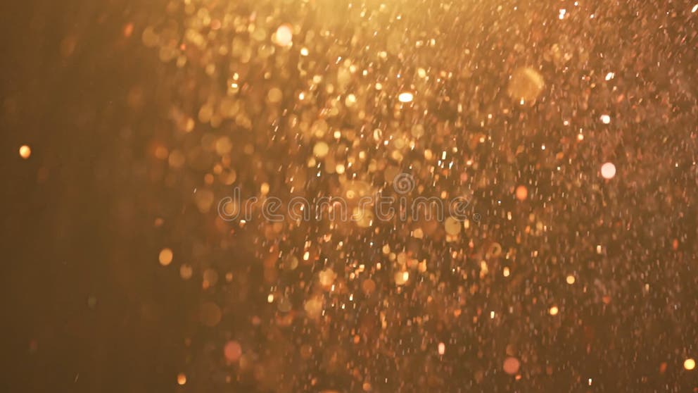 Many Sparkling Glitters Fast Floating in Light on Empty Golden ...