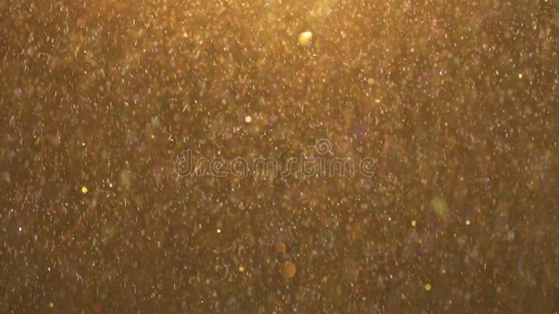 Many Sparkling Glitters Showering Floating in Light on Empty Golden ...