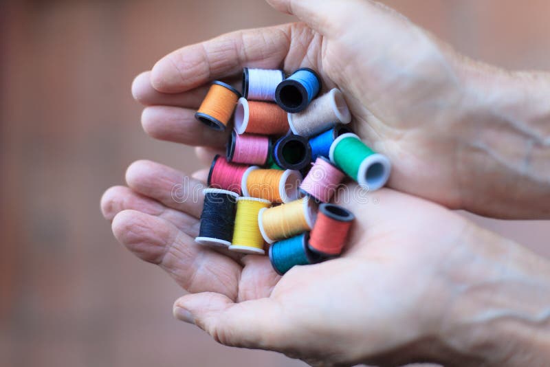 Tiny spools in hands stock image. Image of handwork - 104253177
