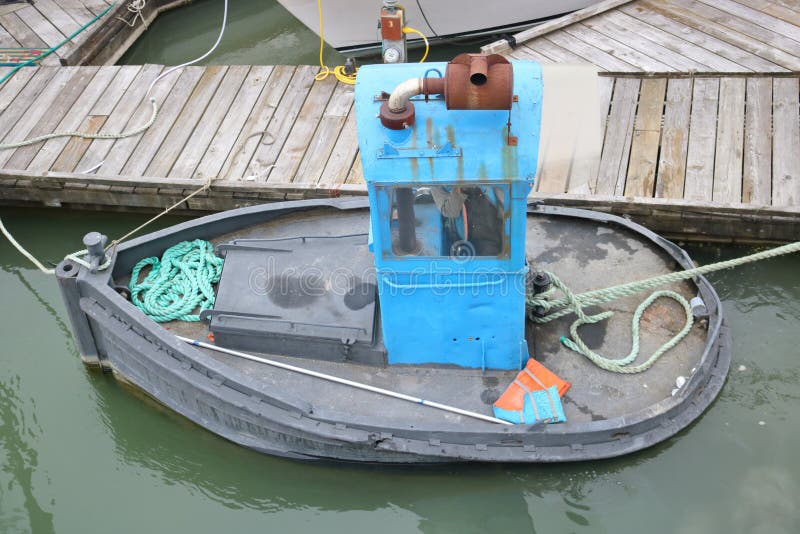 Tiny Tugboat and Dock stock photo. Image of metal, body - 98218540