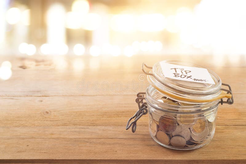 Tip Box, Coin in the Glass Jar in Cafe Front of Mirror Stock Photo ...