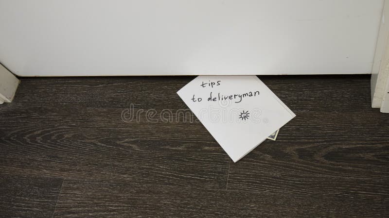 Tip the Courier Delivery in an Envelope Under the Door Stock Photo ...