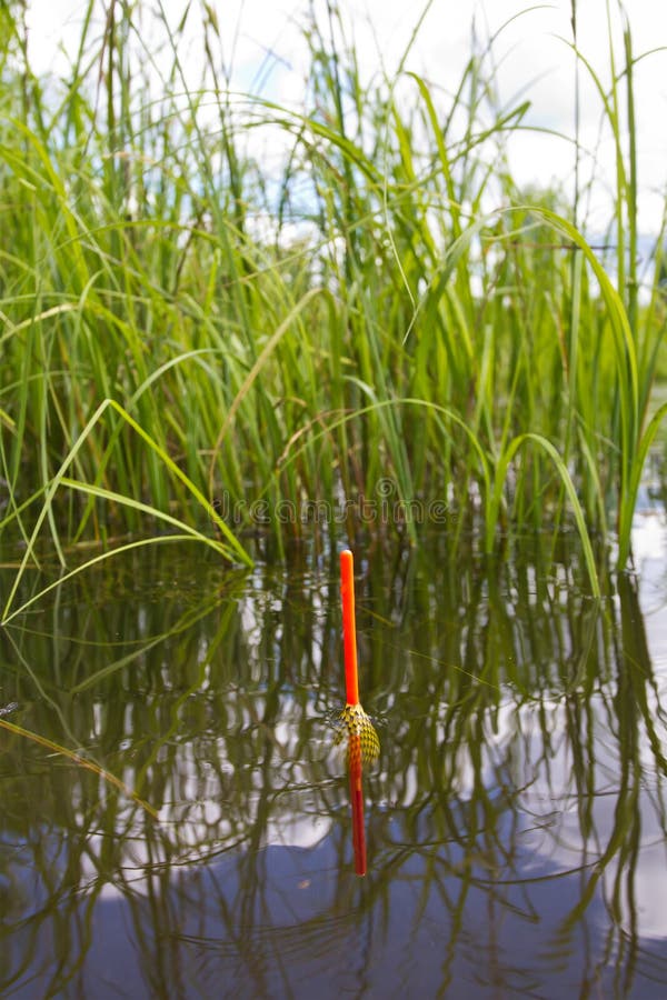 A Float Sits in a an Ice Fishing Hole. Stock Image - Image of arctic ...