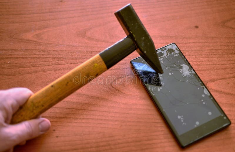 The Tip of the Hammer Hit the Screen of the Smartphone Stock Photo ...