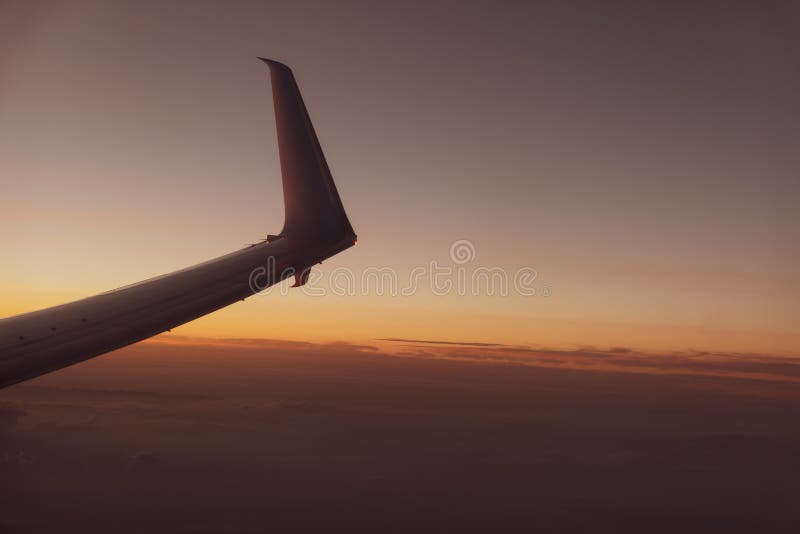 The Tip of a Plane Wing at Sunset Stock Image - Image of wing, light ...