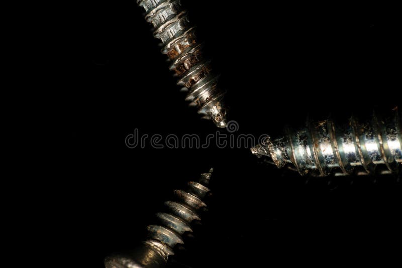 Tip of Three Screws in the Center. Dark Background Stock Image - Image ...