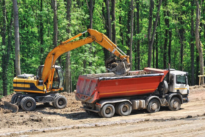 Tipper Truck Loaded by an Excavator Stock Photo - Image of power ...
