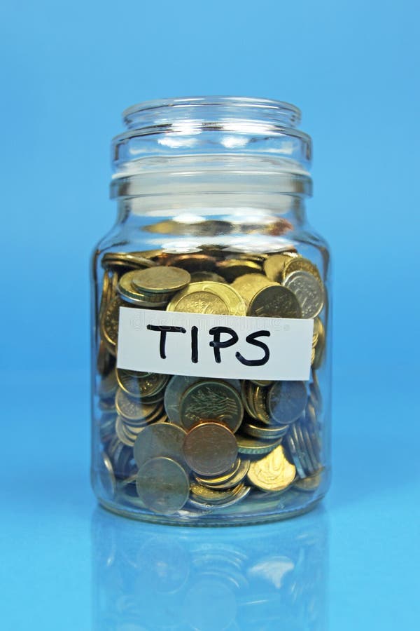 Tips jar filled with coins stock image. Image of metal - 47557337
