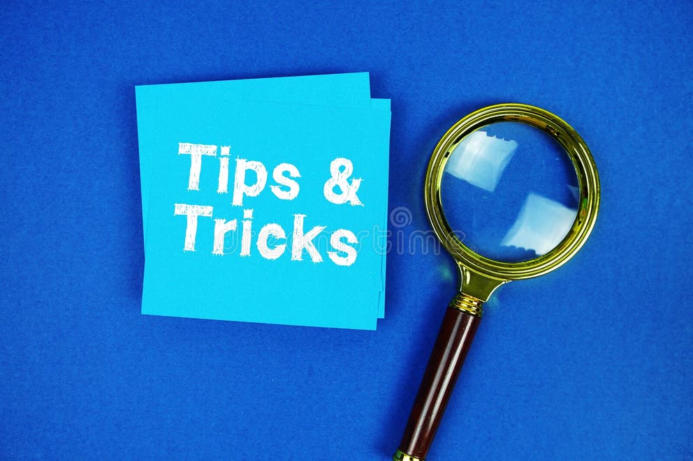 Tips and Tricks Text on Sticky Note with Magnifying Glass on Navy Blue ...