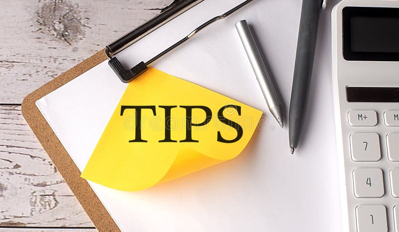 TIPS Word on Yellow Sticky with Calculator, Pen and Clipboard Stock ...