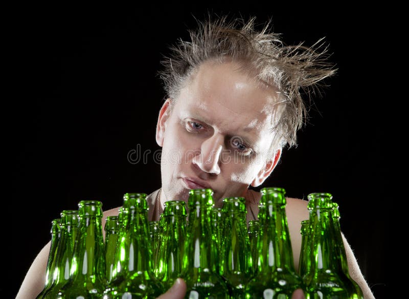 The Tipsy Man Sits with a Heap of Beer Bottles, a Hangover Stock Image ...