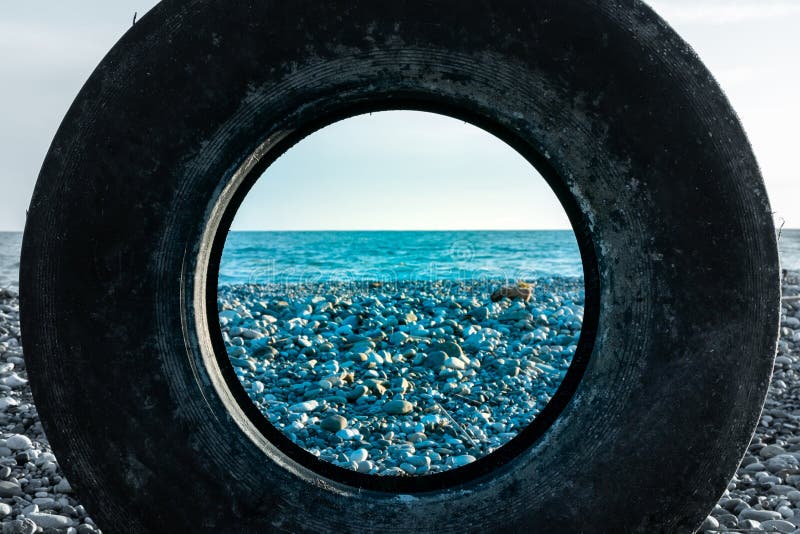 A Tire from a Car Tire through Which the Sea is Visible Stock Photo ...