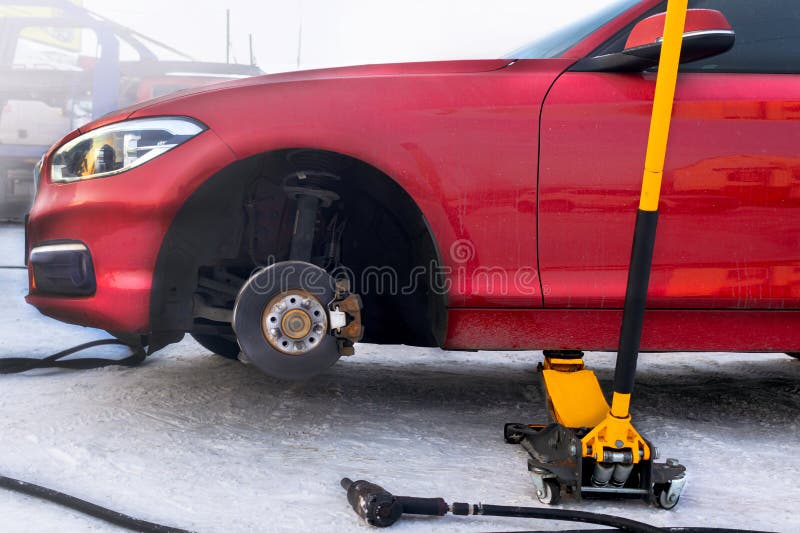 Tire Fitting on the Street. Jack Red Car Stock Photo - Image of ...