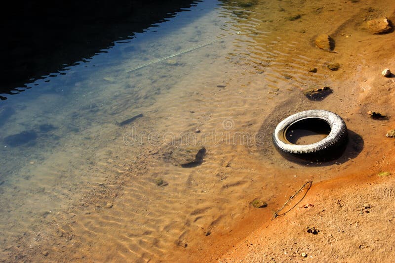 A tire in the river stock photo. Image of river, desolate - 4469604