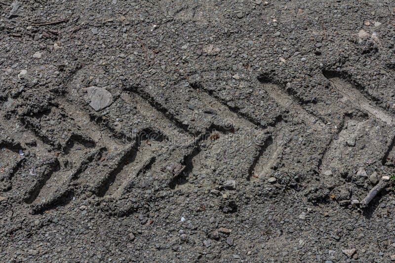 Detailed Tire Track Pattern Imprinted on a Gravel Surface Showing Signs ...