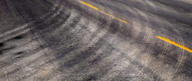 Tire Tracks Turning on Road with Yellow Stripe Lines Stock Photo ...