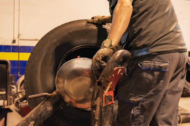 Tire workshop operator stock photo. Image of work, maintenance - 213905040