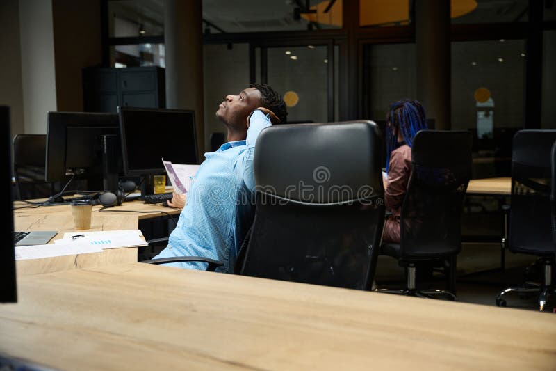 Tired African American Office Worker Taking a Break Leaning on Chair ...