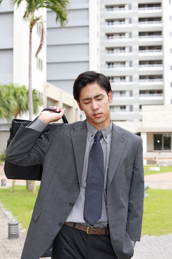 Tired Asian businessman stock image. Image of melancholy - 57169459