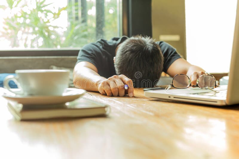 Tired Asian Man with Head Down on Computer Laptop while Working. Stock ...